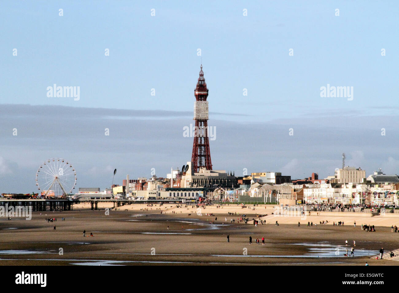 People on the beach at Blackpool with the tower and central pier in the ...