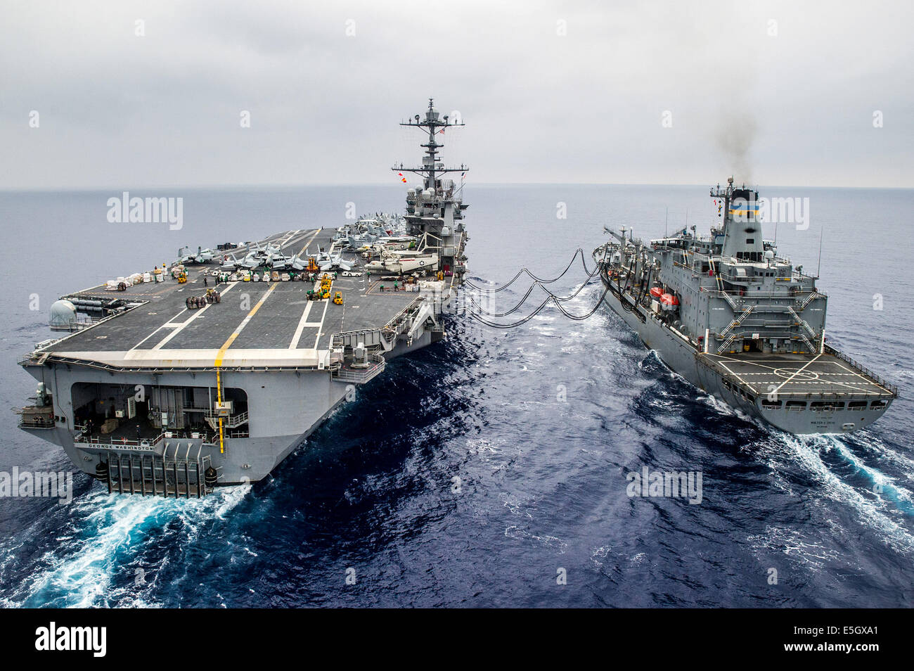 The fleet replenishment oiler USNS Walter S. Diehl (T-AO 193), right ...