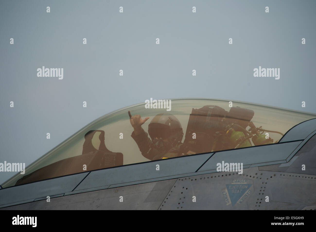 A U.S. Air Force F-22 Raptor aircraft pilot with the 154th Wing signals ...