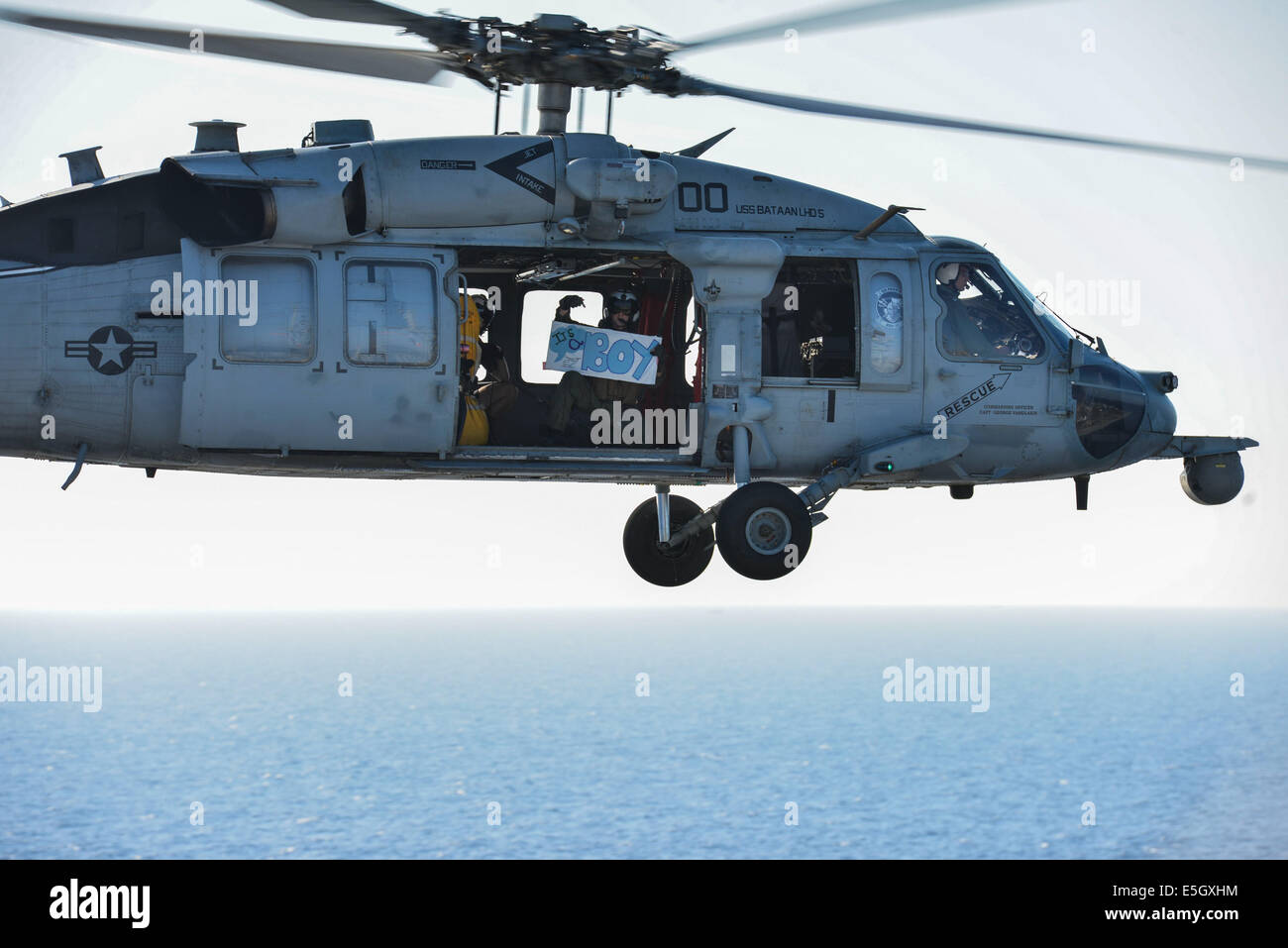 U.S. Naval Aircrewman (Helicopter) 2nd Class Brandon Coan shows an "It ...