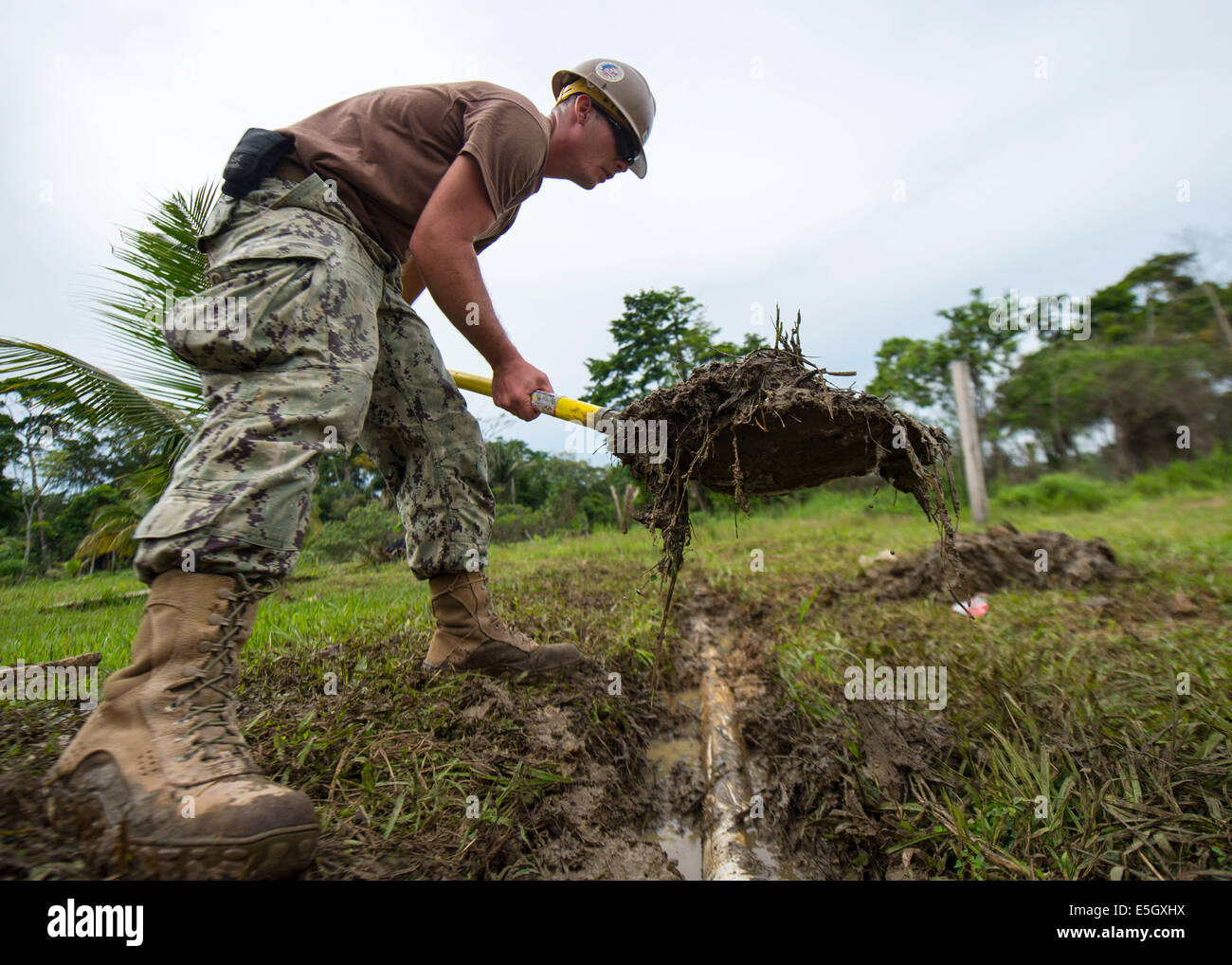 U.S. Navy Engineering Aide Constructionman Keith Willett works on a ...