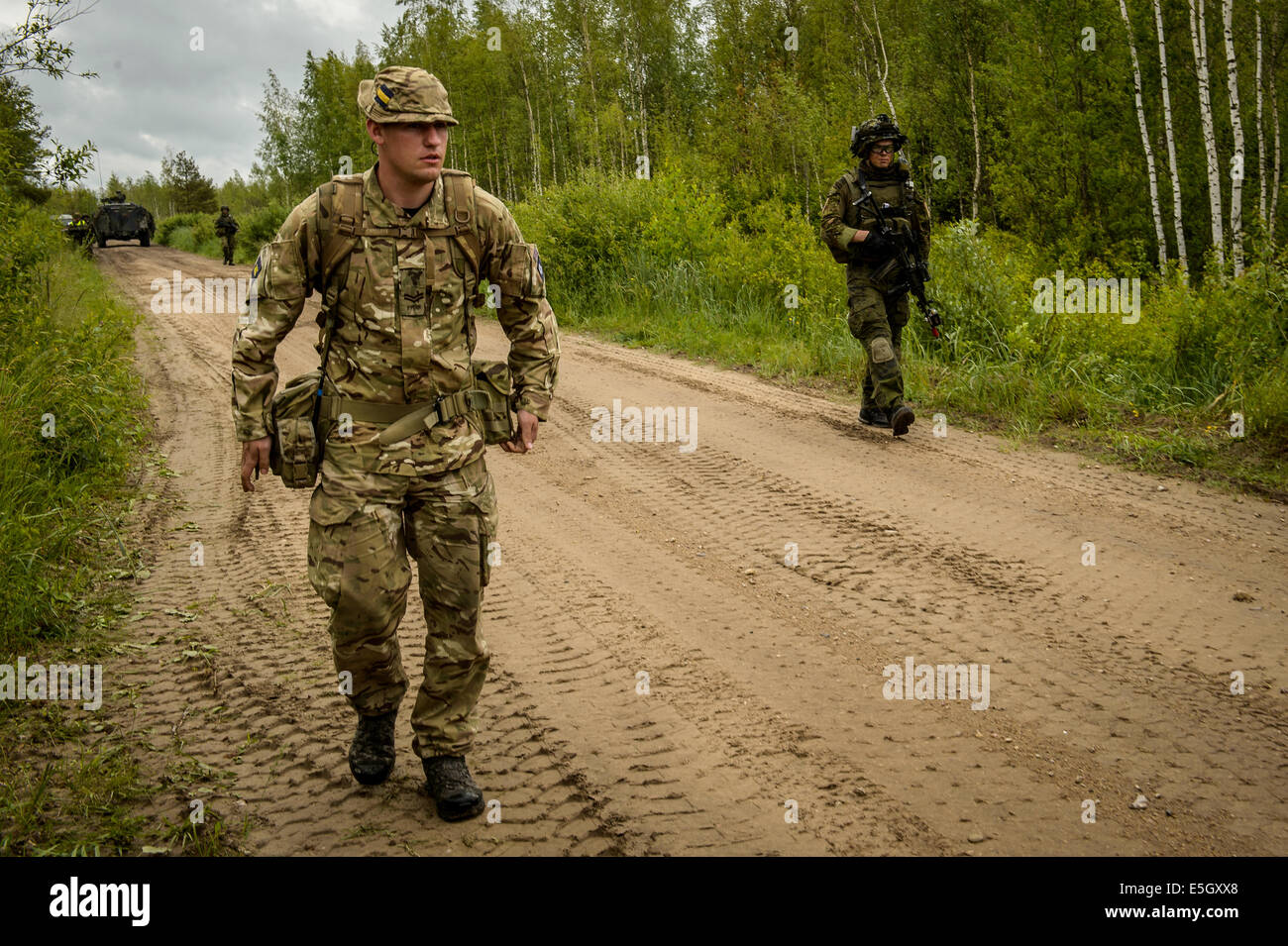 British Army Cpl. Rob Lush, left, an observer coach trainer with Saber ...