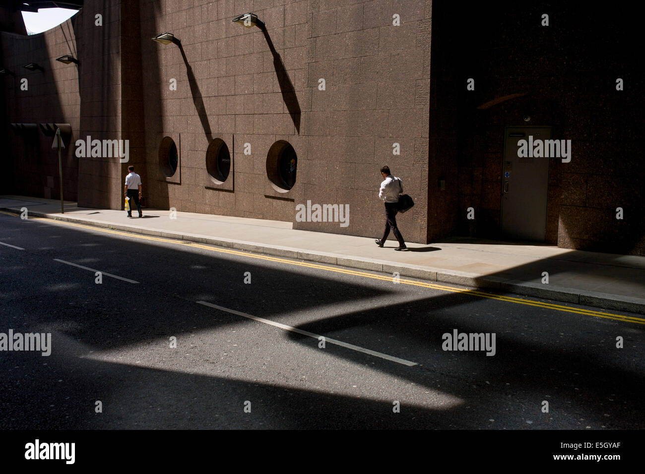 Strangers walk through urban landscape of modern architecture at ...