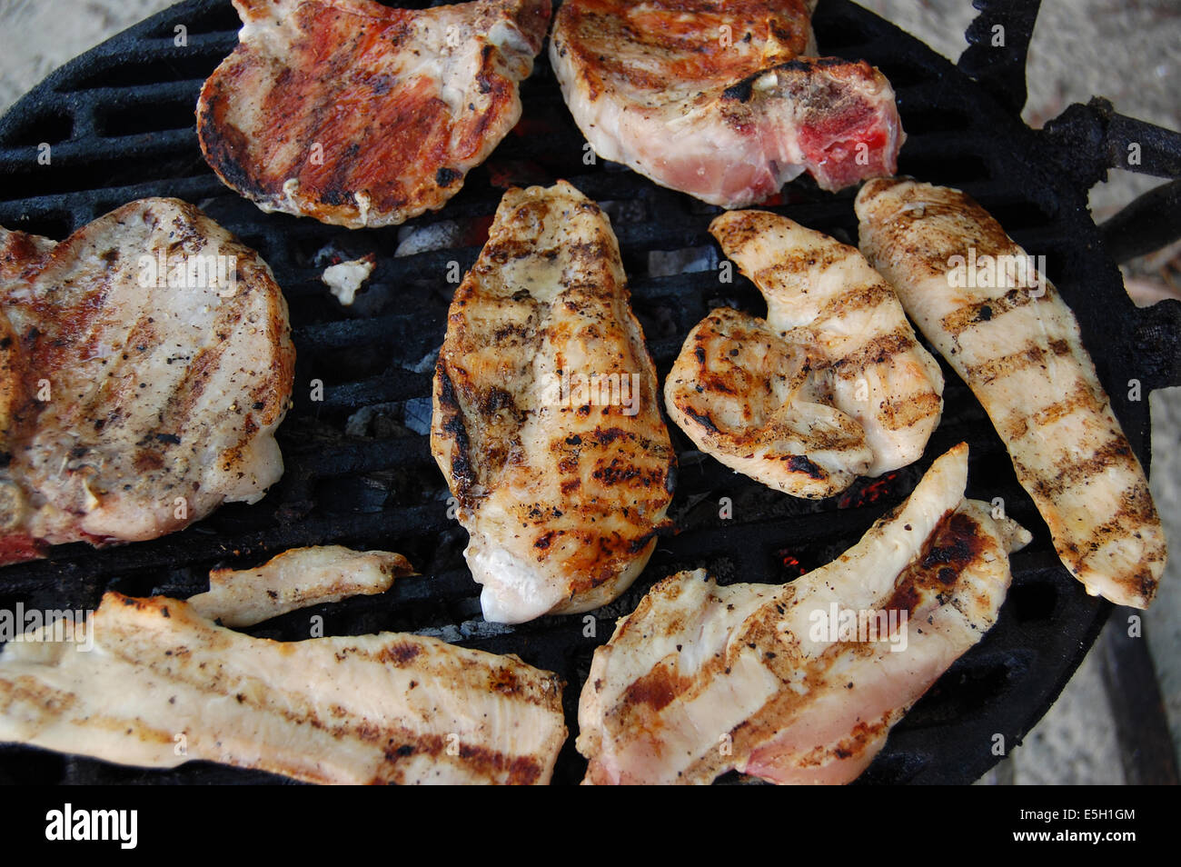 More types of meat roasted on a grill Stock Photo - Alamy