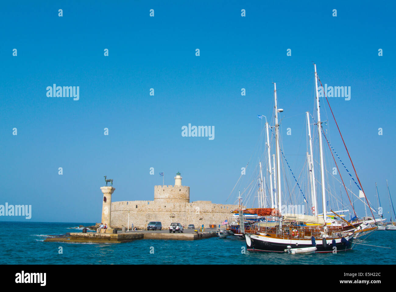 Castle and lighthouse of Agios Nikolaos, Mandraki port, Rhodes town ...