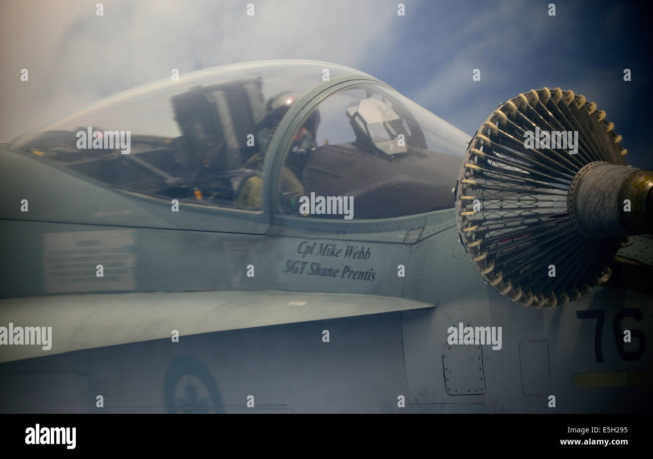 A Royal Canadian Air Force (RCAF) CF-18 Hornet aircraft connects to the ...