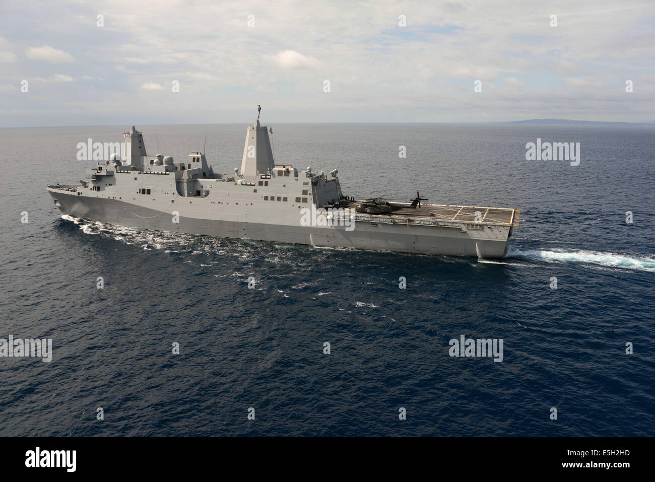 The amphibious transport dock ship USS Anchorage (LPD 23) sails off the ...