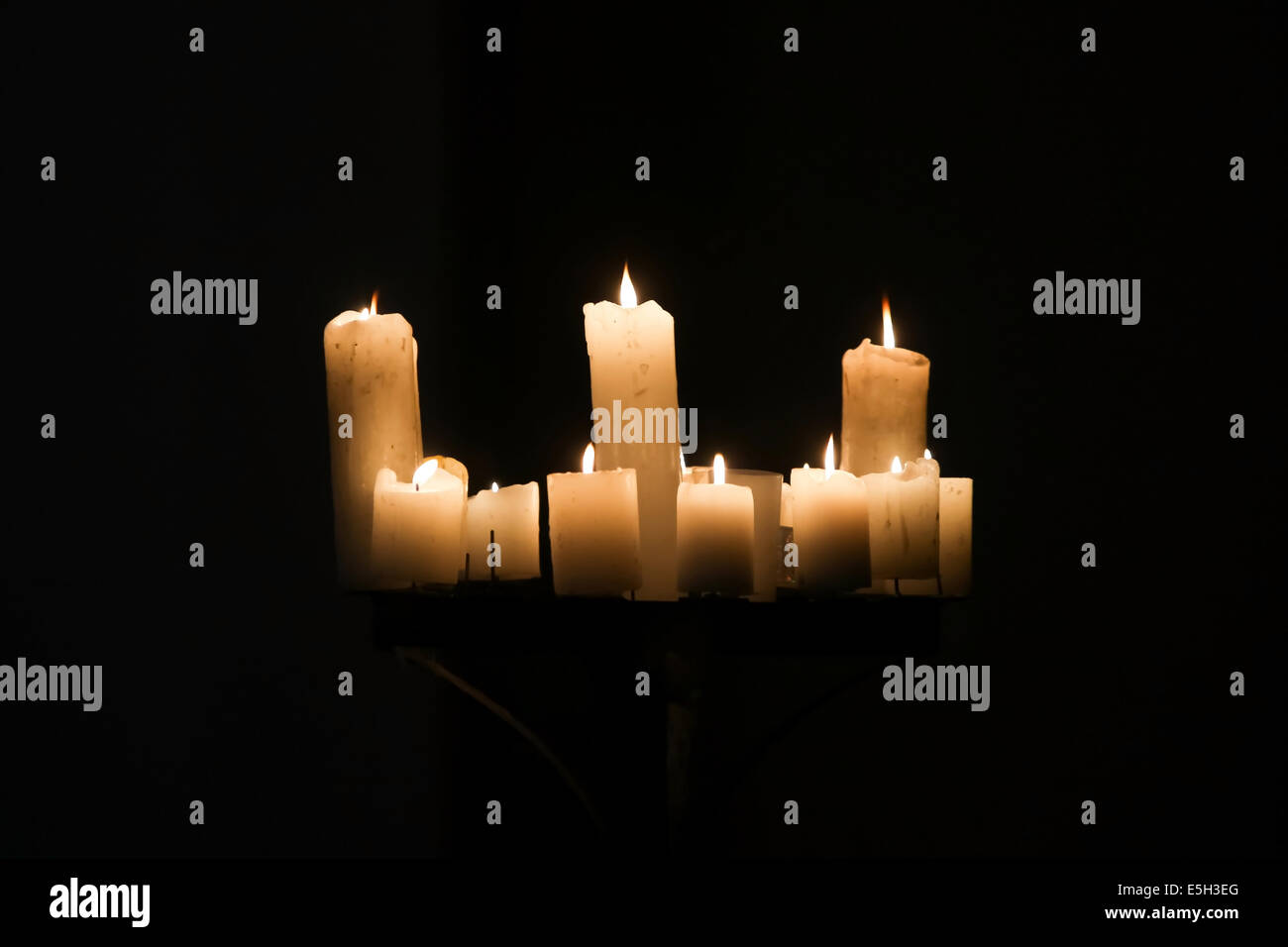 Burning candles on black background Stock Photo - Alamy