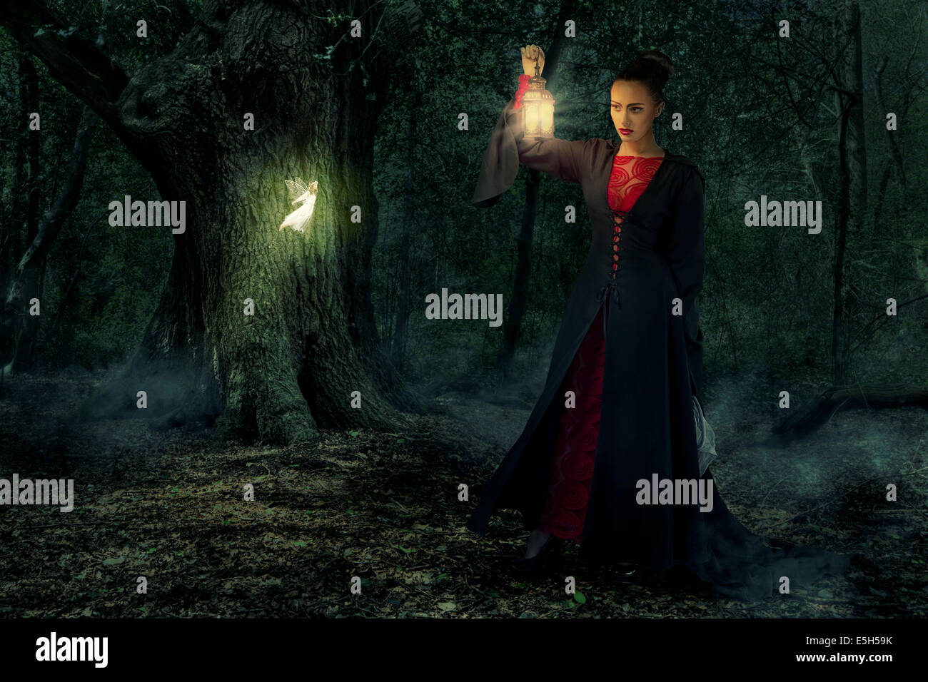 Bad queen catching fairies fairy-tale Stock Photo - Alamy