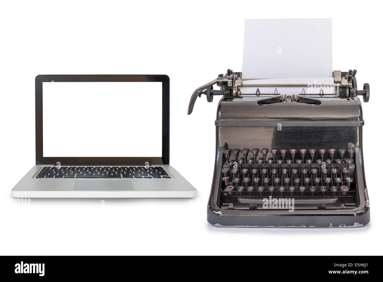 Modern silver laptop and an old black typewriter isolated on white ...
