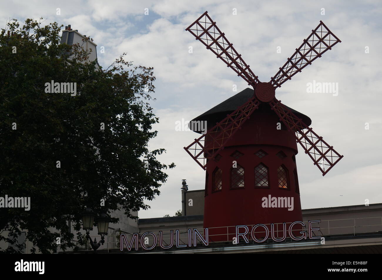 Moulin Rouge marked by the red windmill on its roof Stock Photo - Alamy