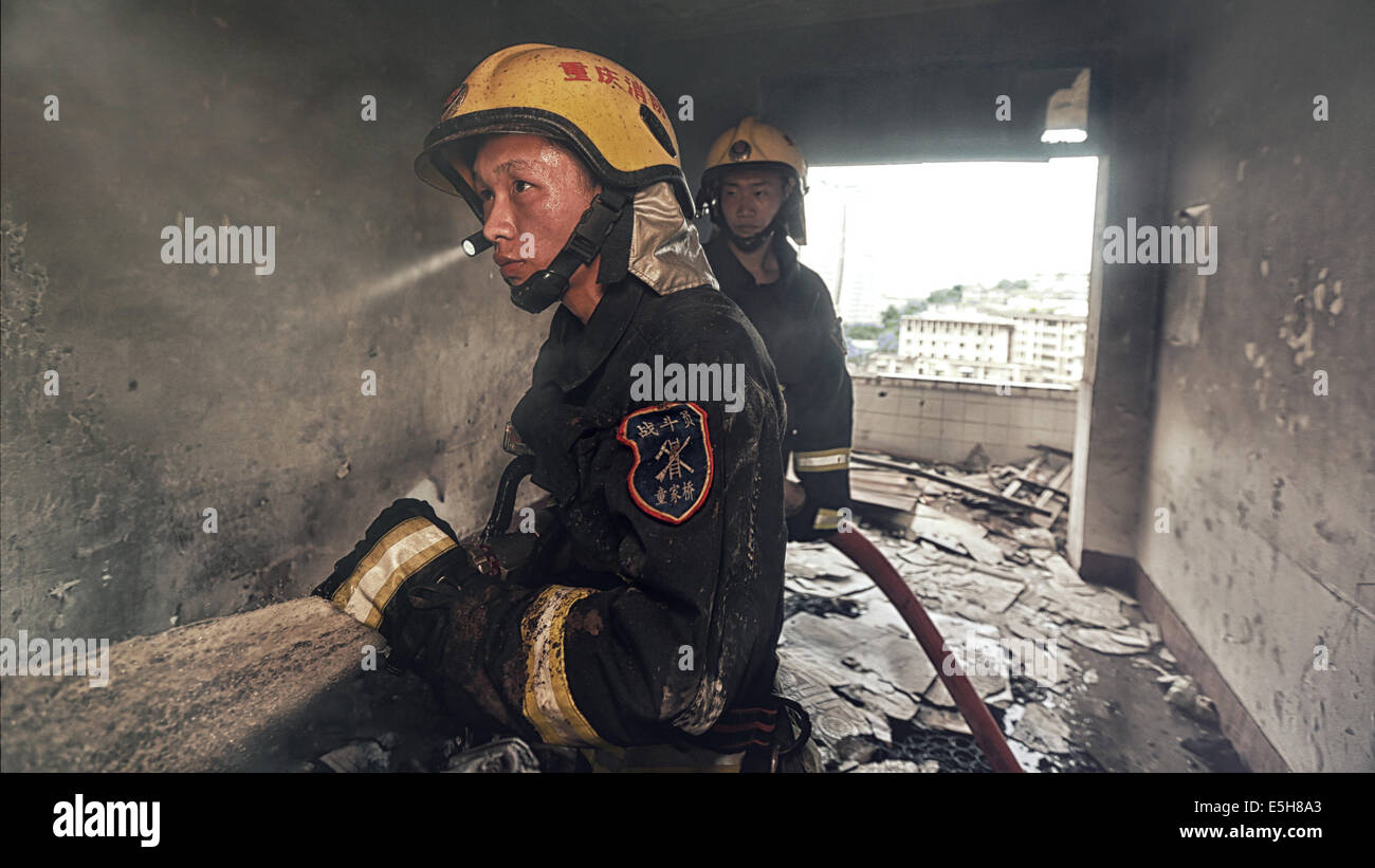 Chongqing, China. 23rd Aug, 2013. Firefighter Chen Jihang (front), a ...