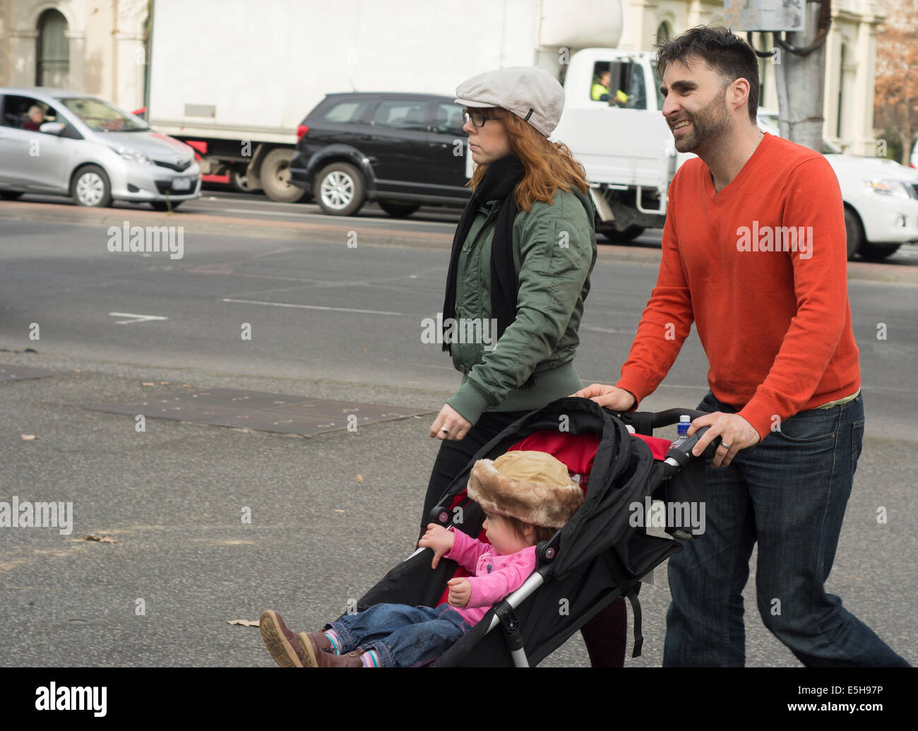 Family couple anxious father pushing pram Stock Photo - Alamy