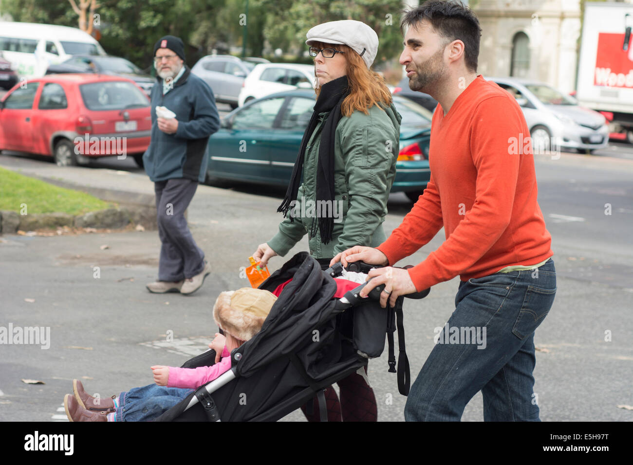 Family couple anxious father pushing pram Stock Photo - Alamy