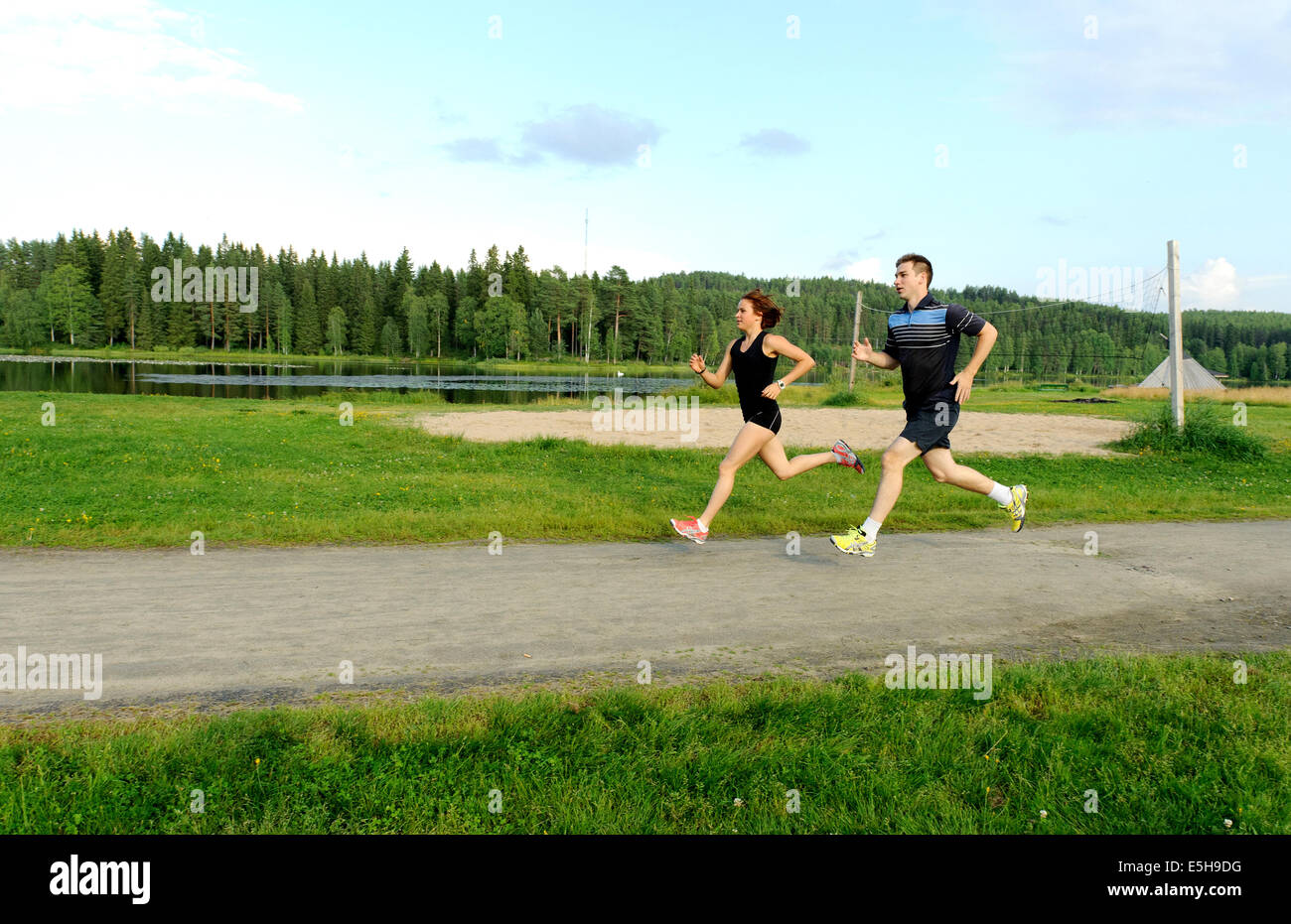 Young couple running outside Stock Photo - Alamy