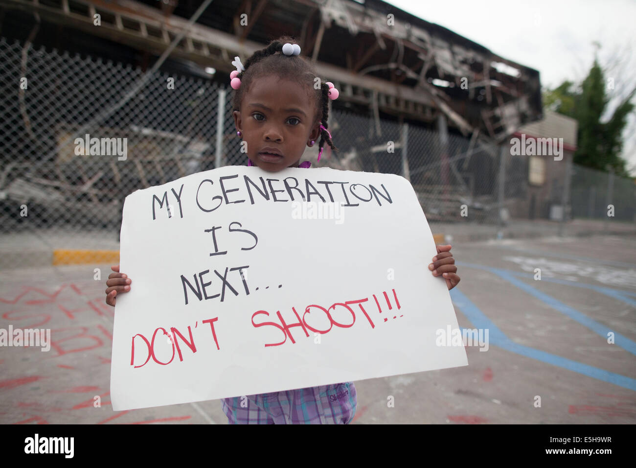 Ferguson, Missouri, USA. 15th Aug, 2014. A girl holds a placard during ...