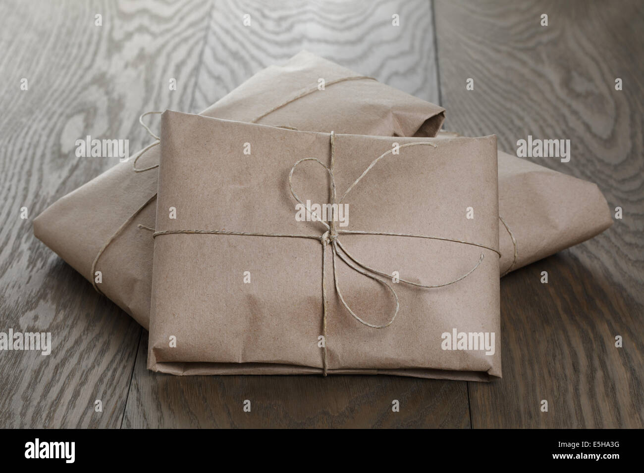vintage style parcels wrapped with rope, on old oak table Stock Photo ...