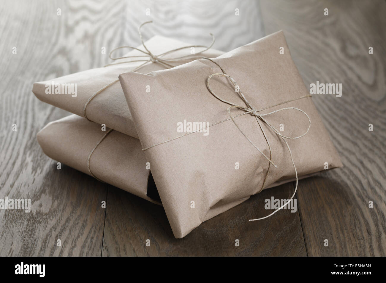 vintage style parcels wrapped with rope, on old oak table Stock Photo ...