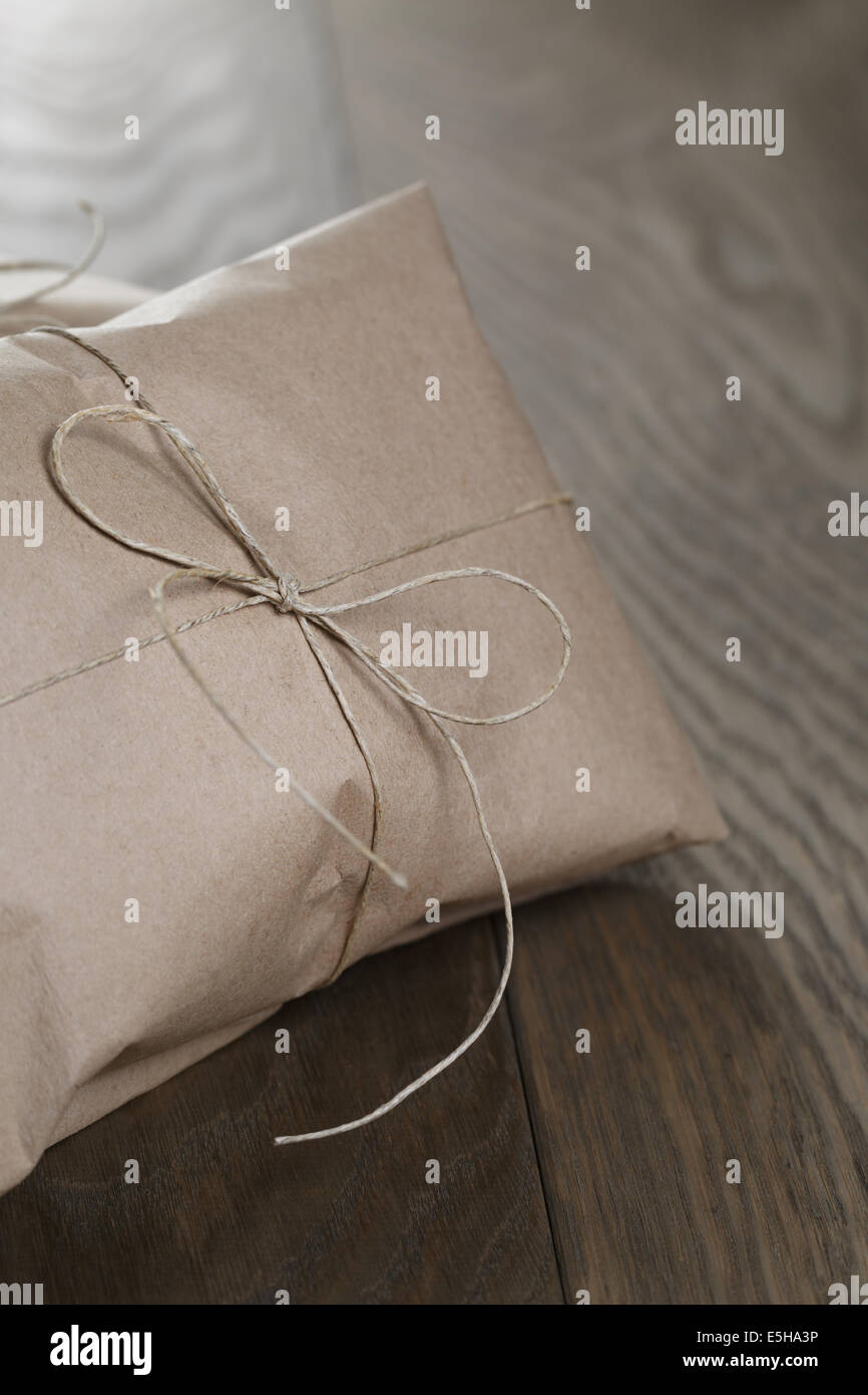 vintage style parcel wrapped with rope, on old oak table Stock Photo ...