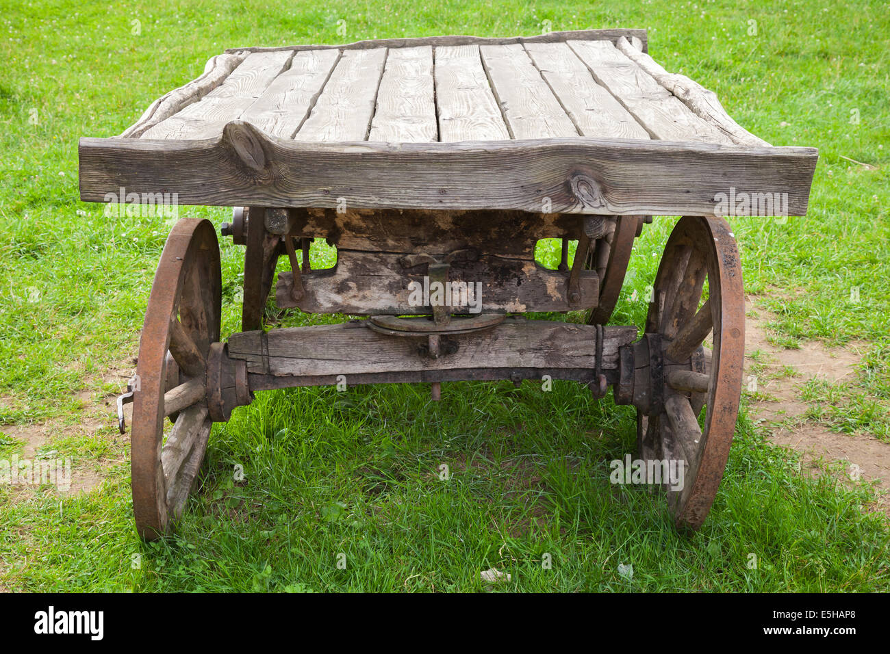 Empty old rural wooden wagon stands on green summer grass Stock Photo ...