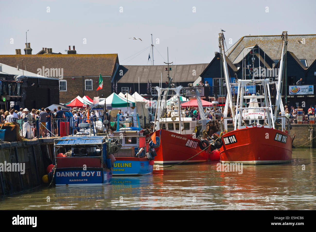Fishing boats moored in harbour during Whitstable Oyster Festival at ...