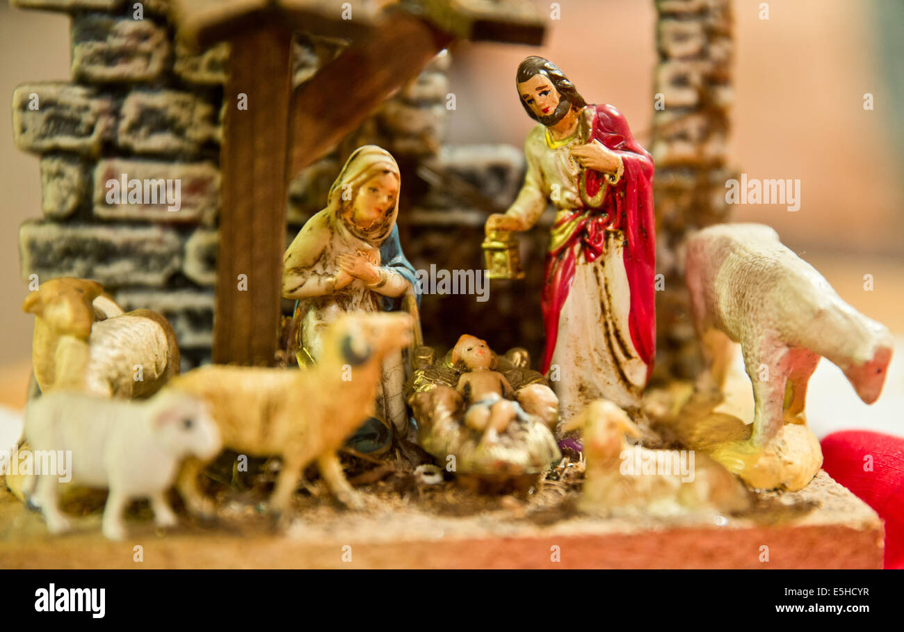 A Christmas crèche with Mary, Joseph and baby Jesus stands on a table ...
