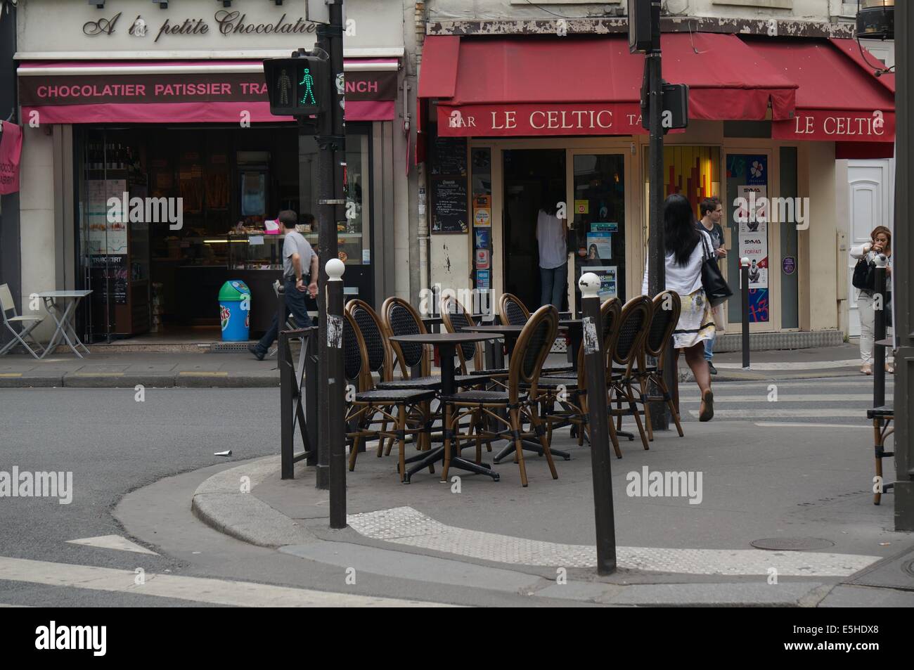 Pavement cafe terrace at the corner of an intersection in Paris with a ...
