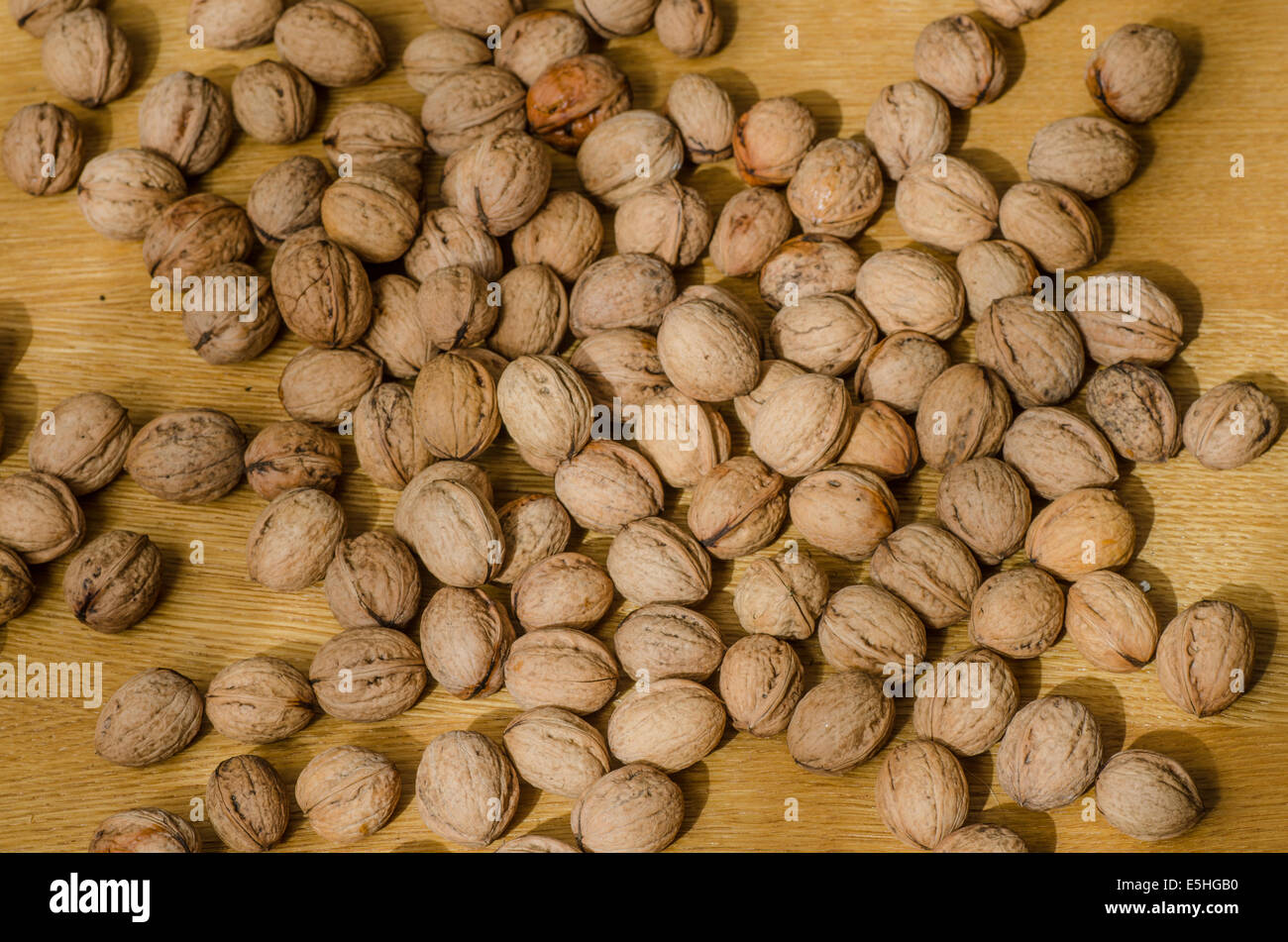 group of walnuts on wooden table Stock Photo - Alamy