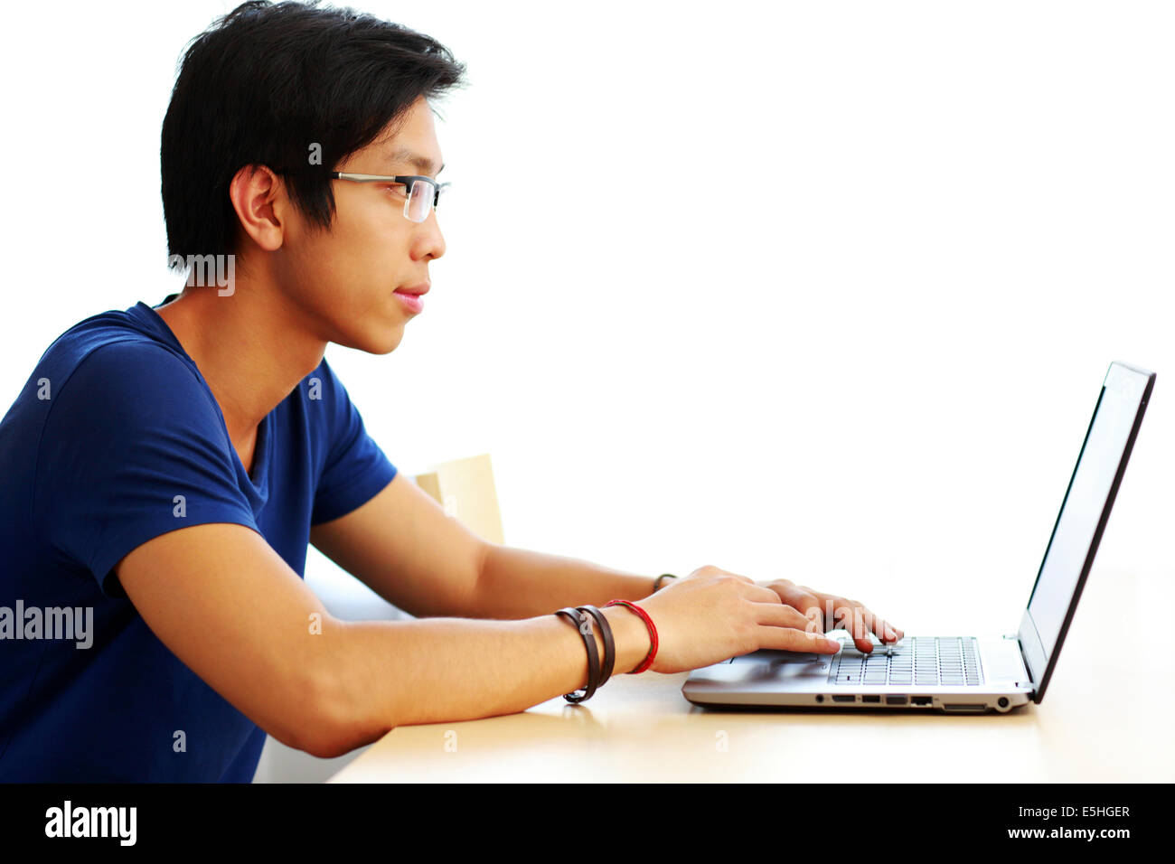 Side view portrait of a young asian man using laptop Stock Photo - Alamy