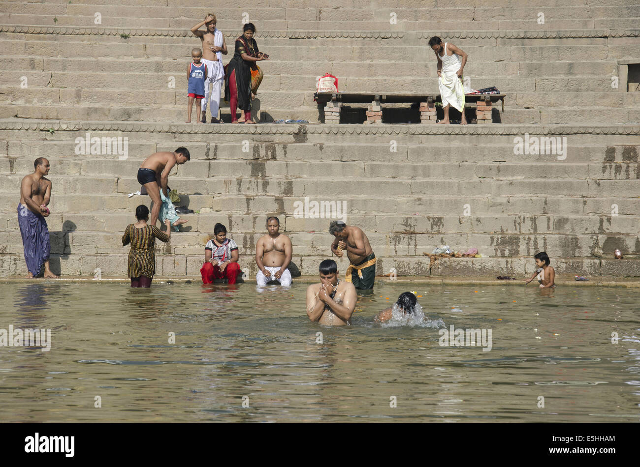 Pilgrims taking a holy bath in the river Ganga, Varanasi, Benares ...