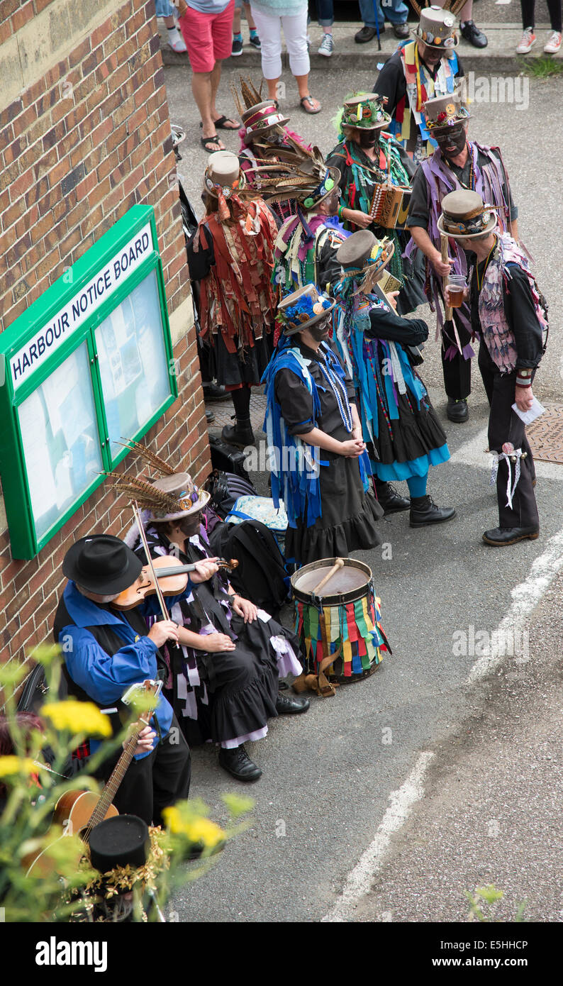 Morris dancers with blackened faces performing on the harbour at ...