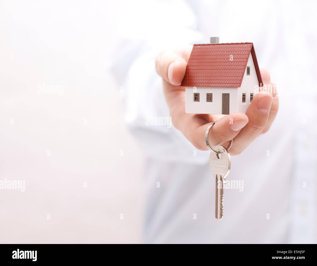 House key in hand Stock Photo - Alamy