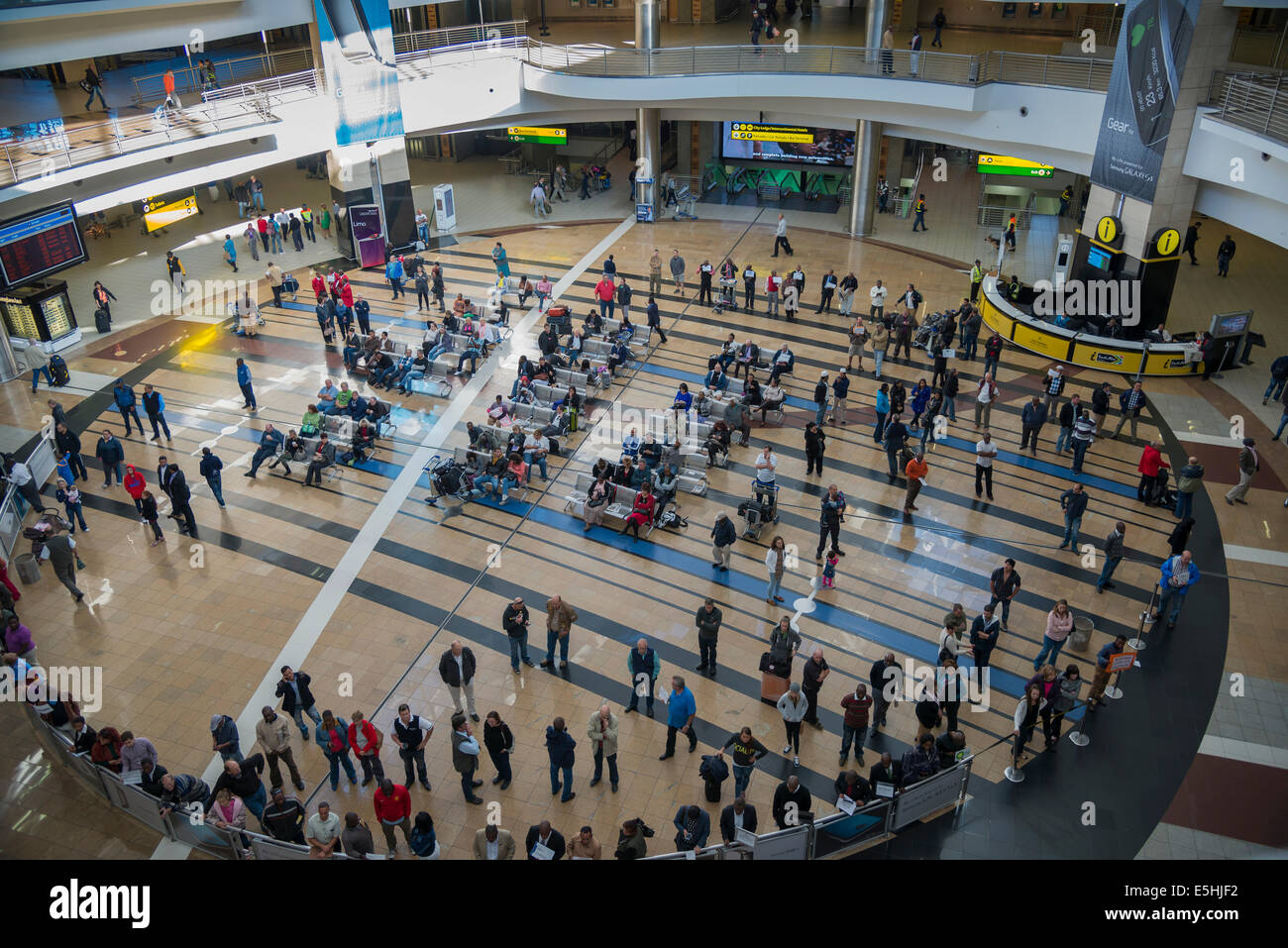 O. R. Tambo International Airport hall with waiting greeters ...