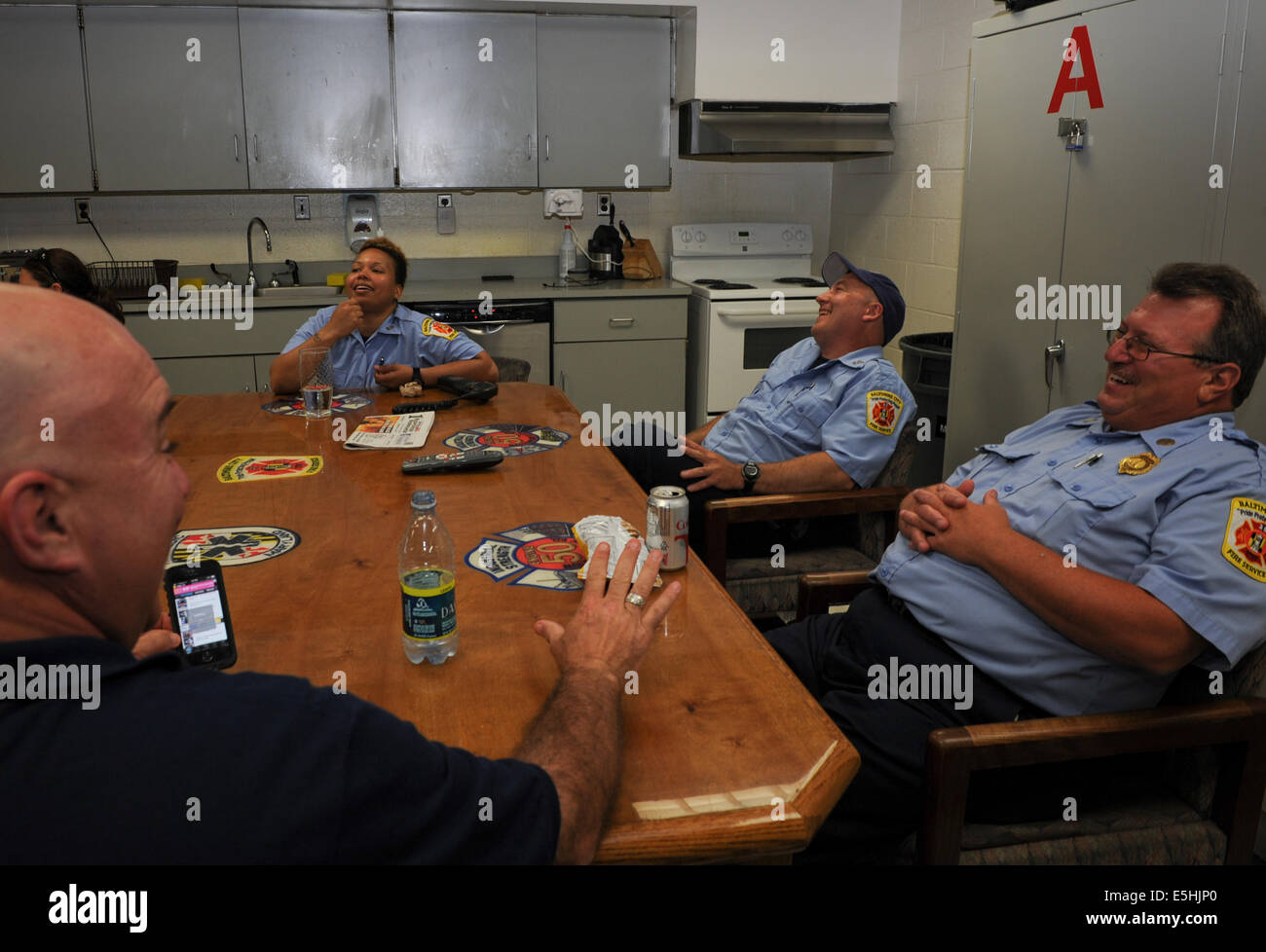 Fire fighters enjoy each other's company during dinner at the firehouse ...
