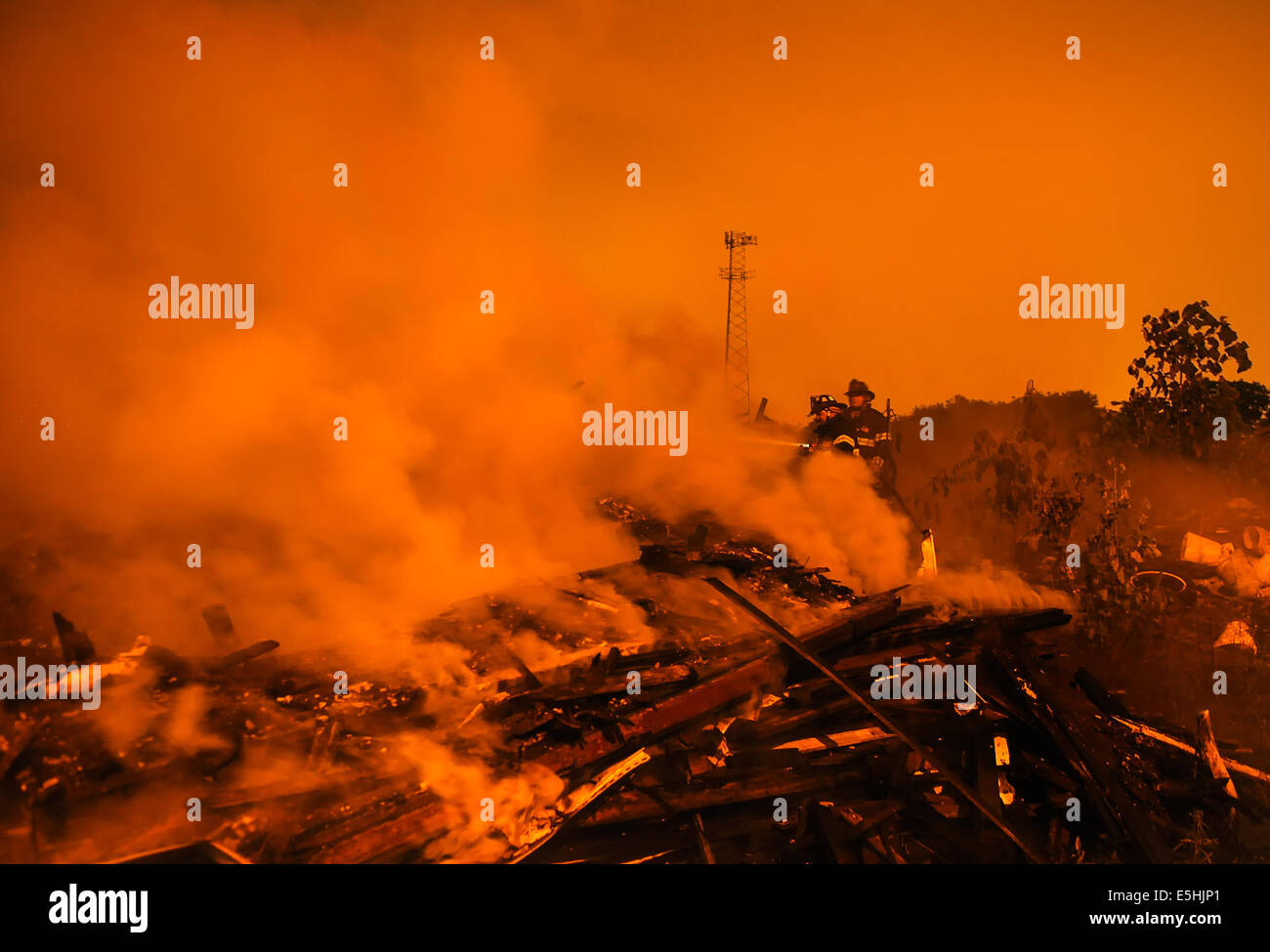 Firefighters fight a junk pile fire in Baltimore Wednesday evening ...