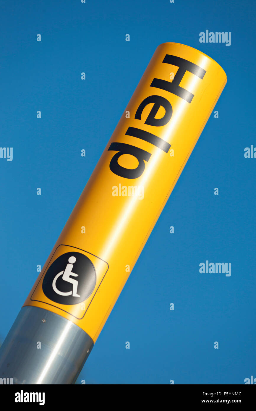 Yellow Help sign against a blue sky Stock Photo - Alamy