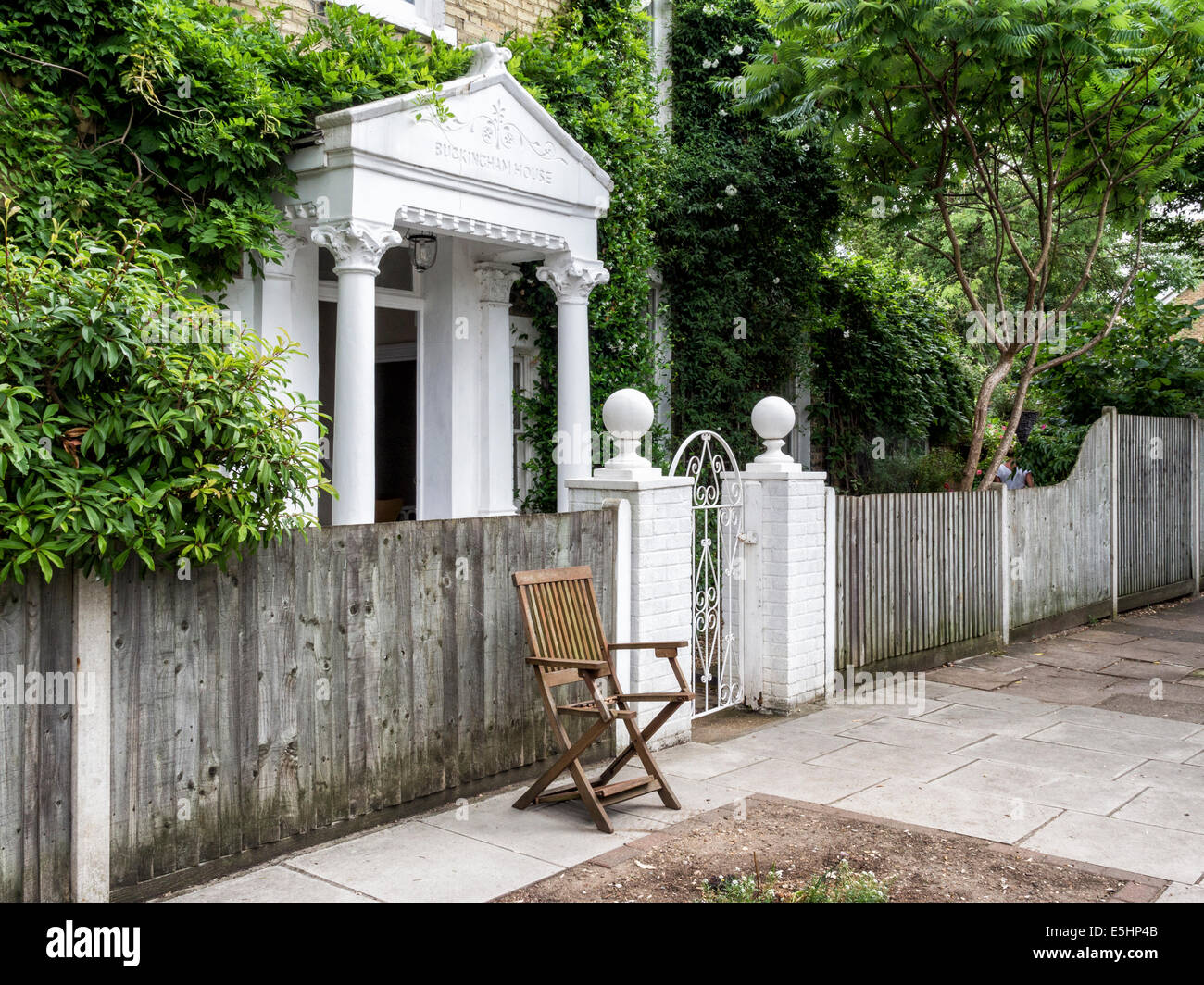 Entrance of elegant suburban home with broken wooden chair at front ...
