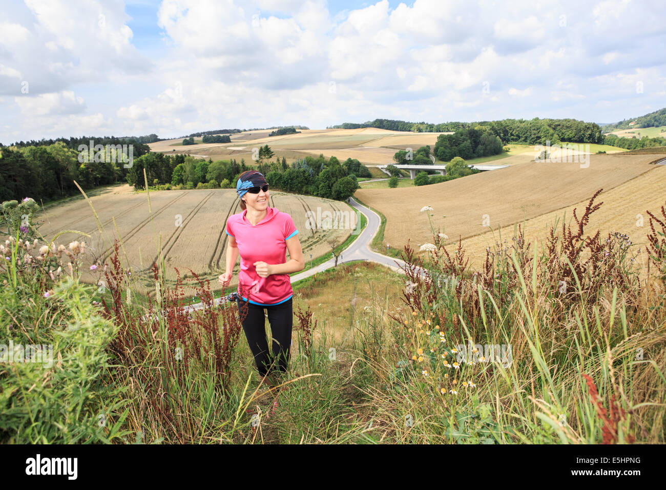 a woman running through the rural landscape Stock Photo - Alamy