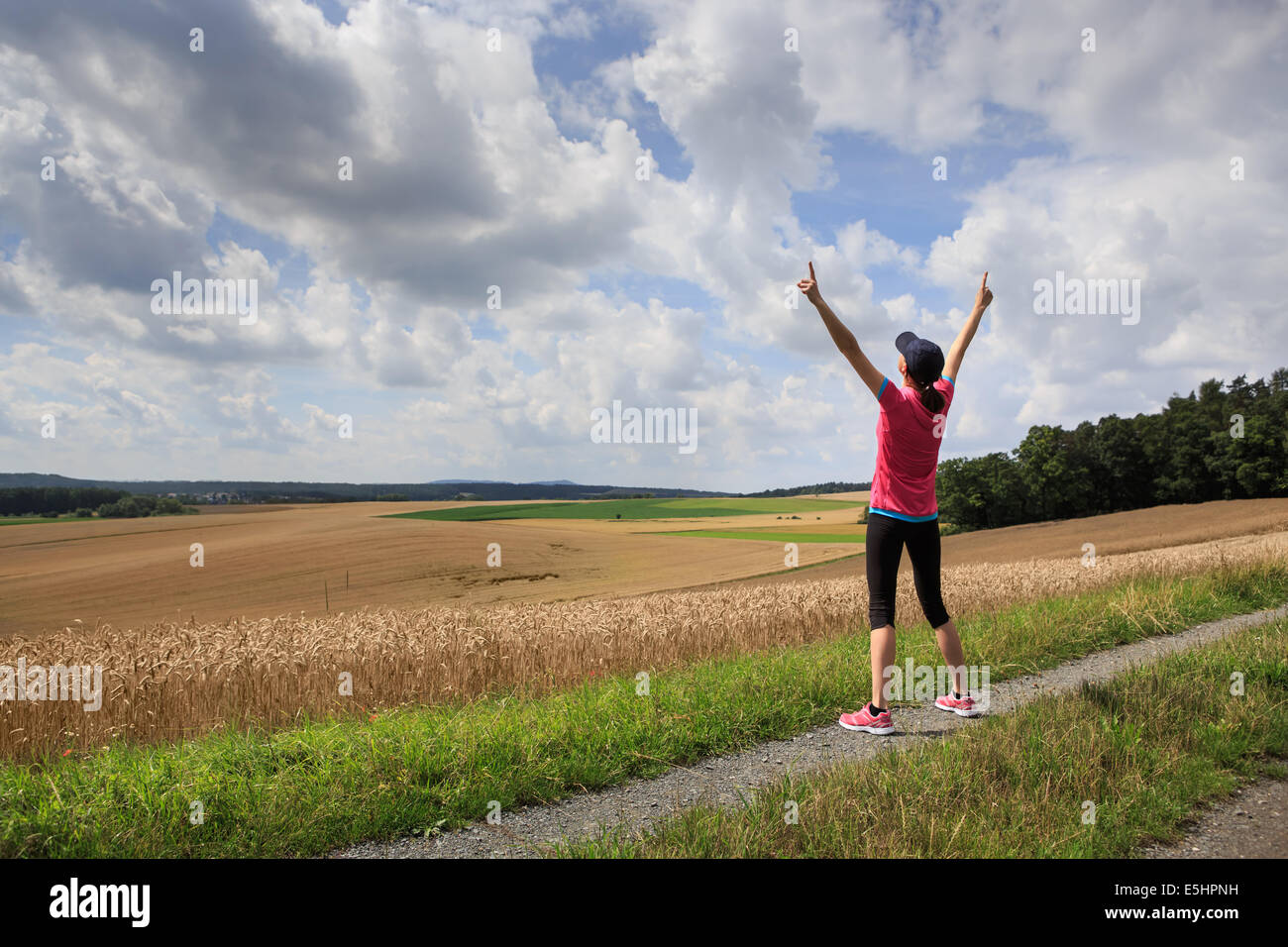 a woman running through the rural landscape Stock Photo - Alamy
