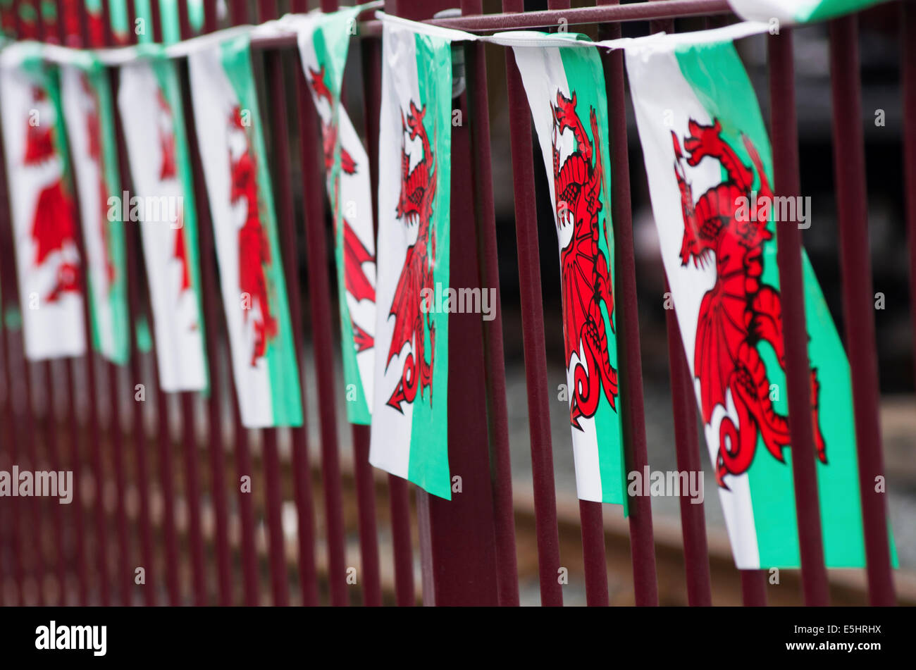 A row of Welsh flags on a red railing Stock Photo - Alamy