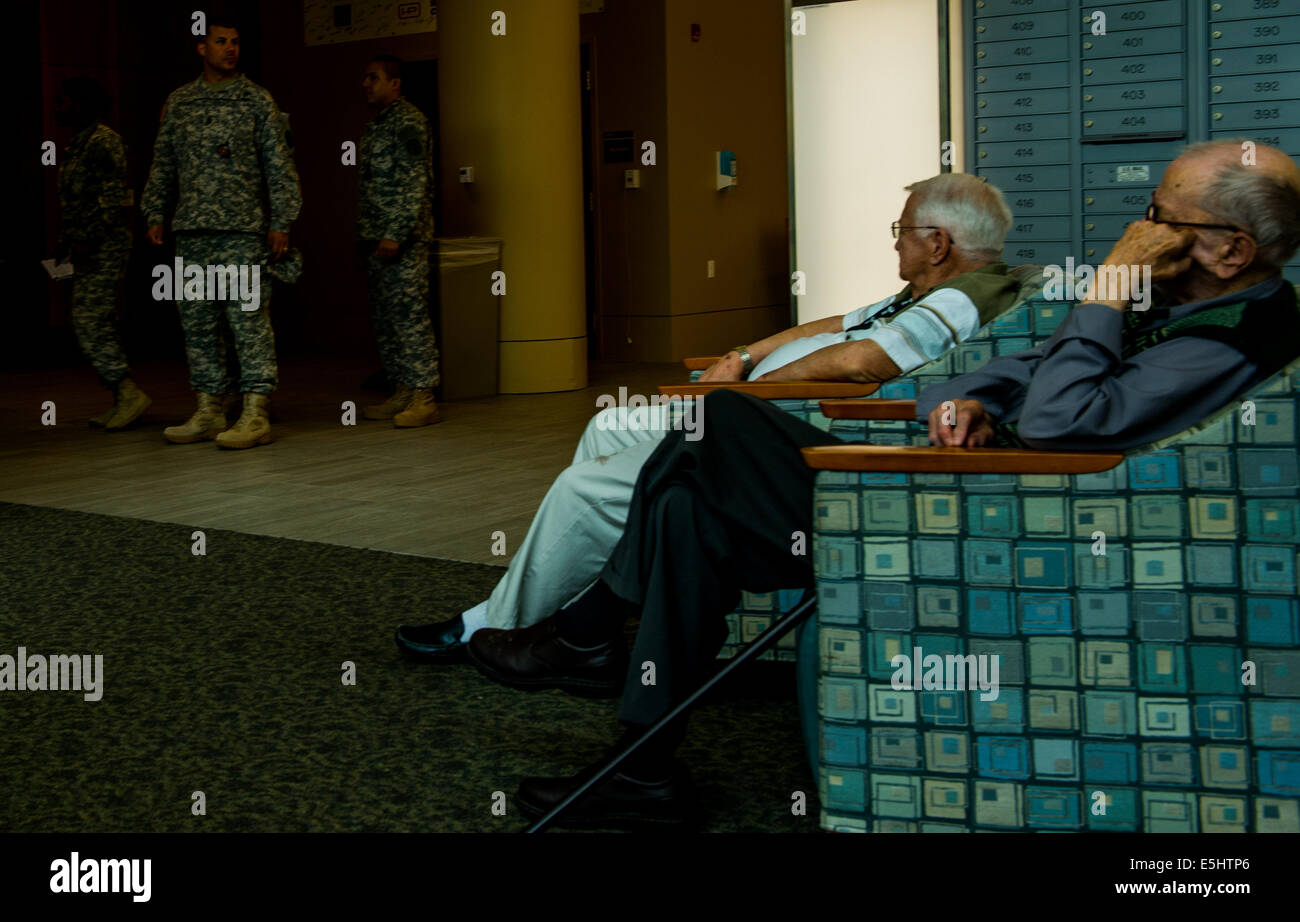 Retired military veterans stare at U.S. Army military members while ...