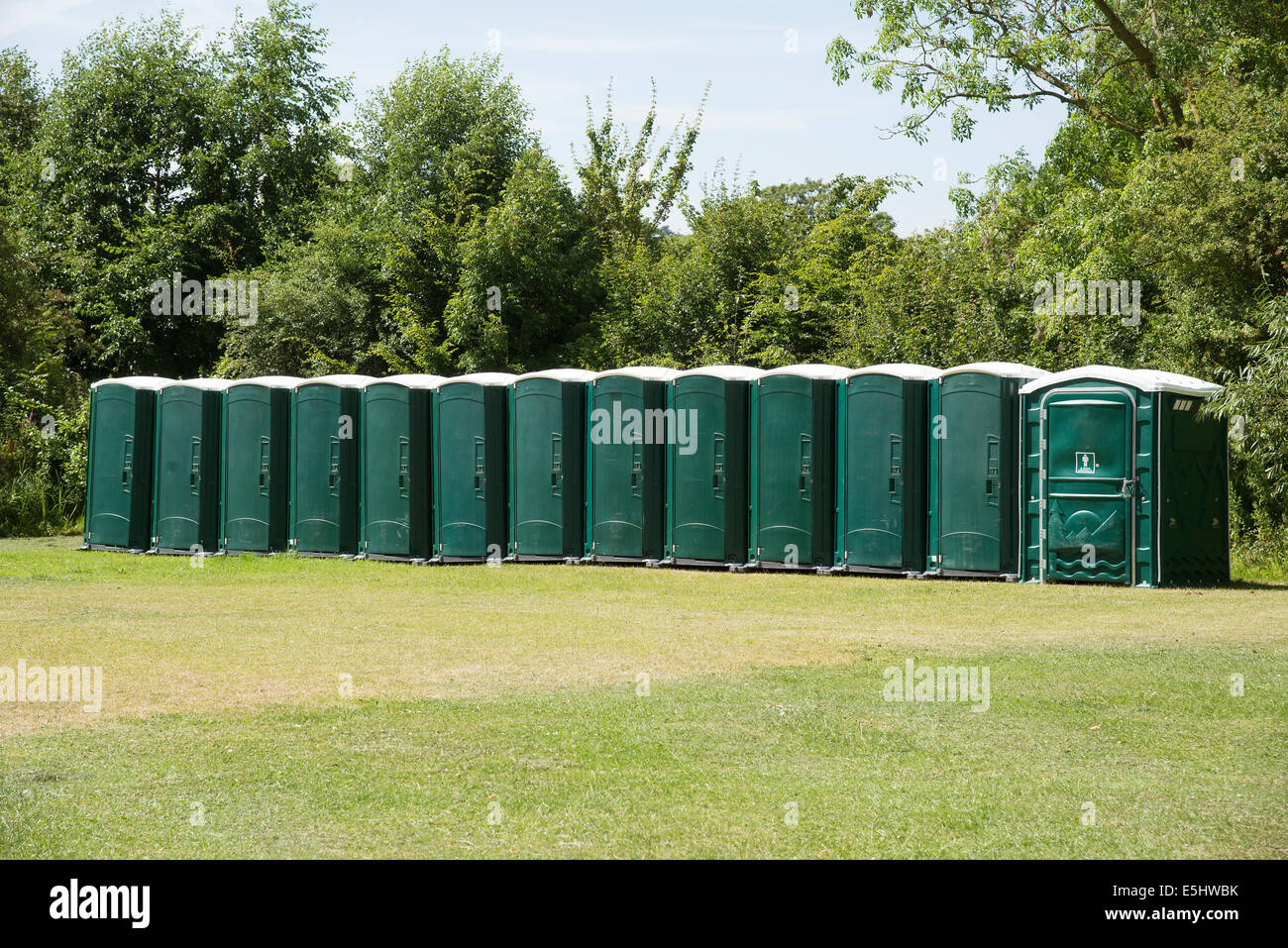 Plastic portable toilets standing in a field Stock Photo - Alamy