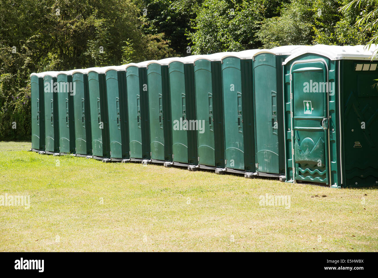 Plastic portable toilets standing in a field Stock Photo - Alamy
