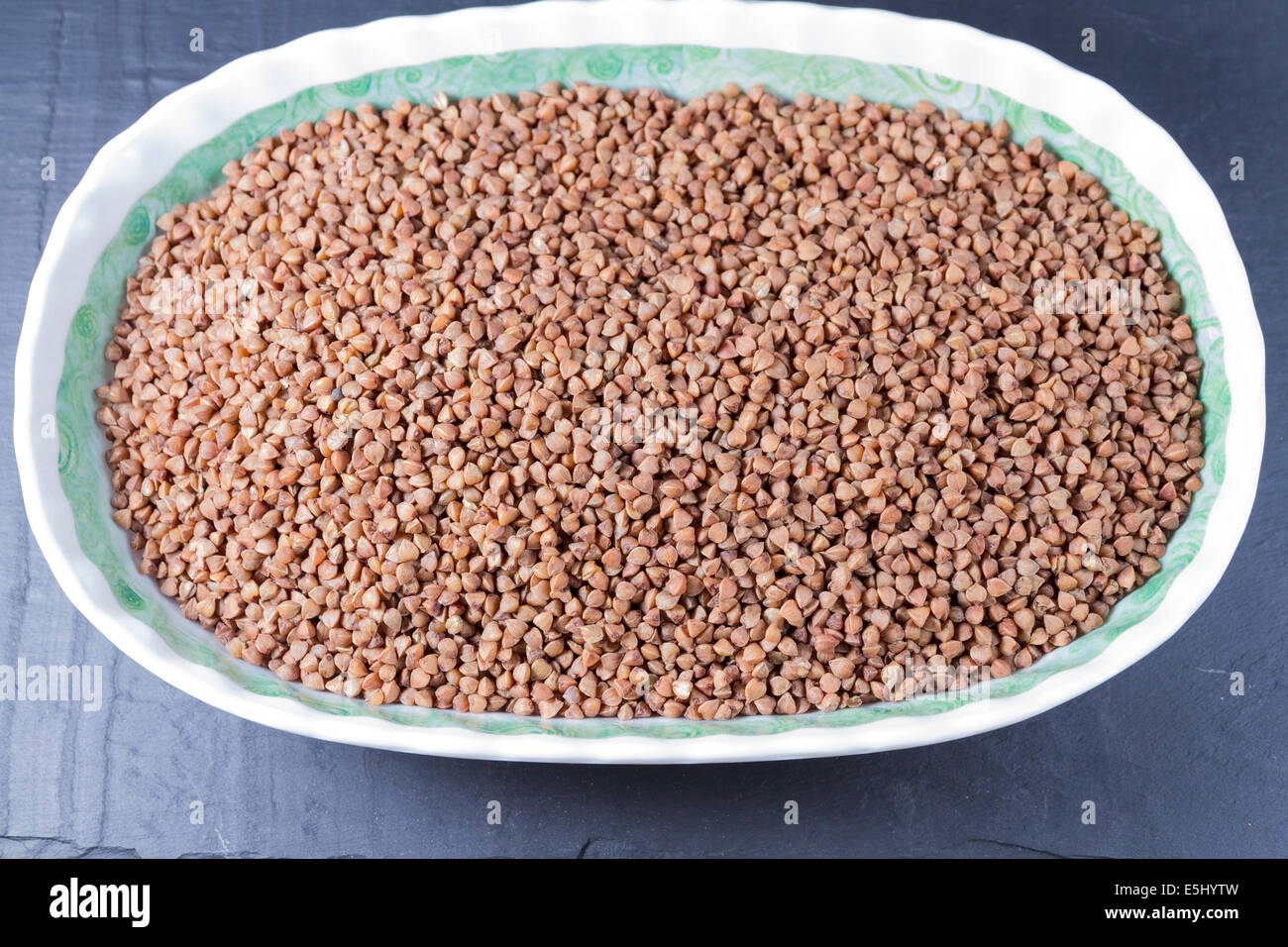 Buckwheat or Grechka in Russian in oval bowl and slate background Stock ...