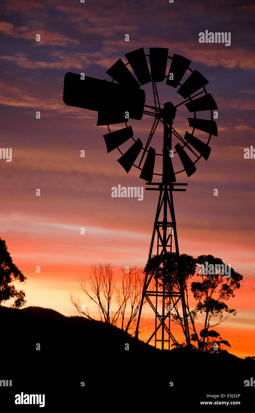 Windmill silhouette and sunset Stock Photo - Alamy