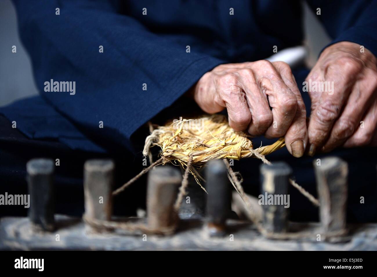 Yudu, China's Jiangxi Province. 1st Aug, 2014. Straw sandal craftsman ...