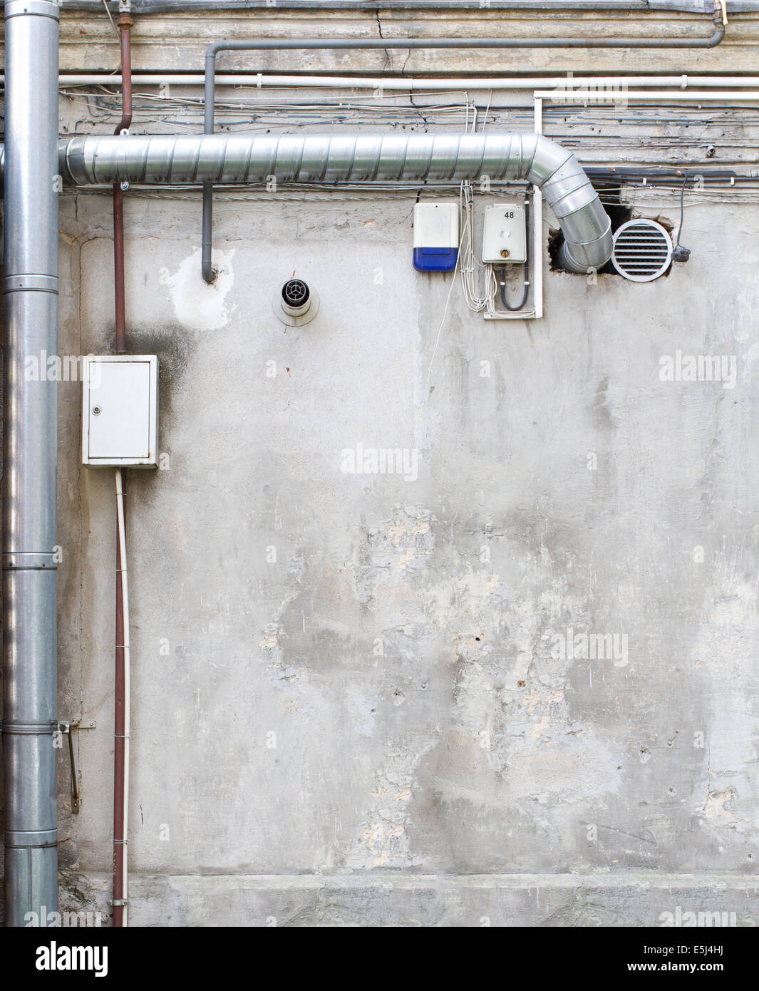 Pipes and wires on the wall Stock Photo - Alamy