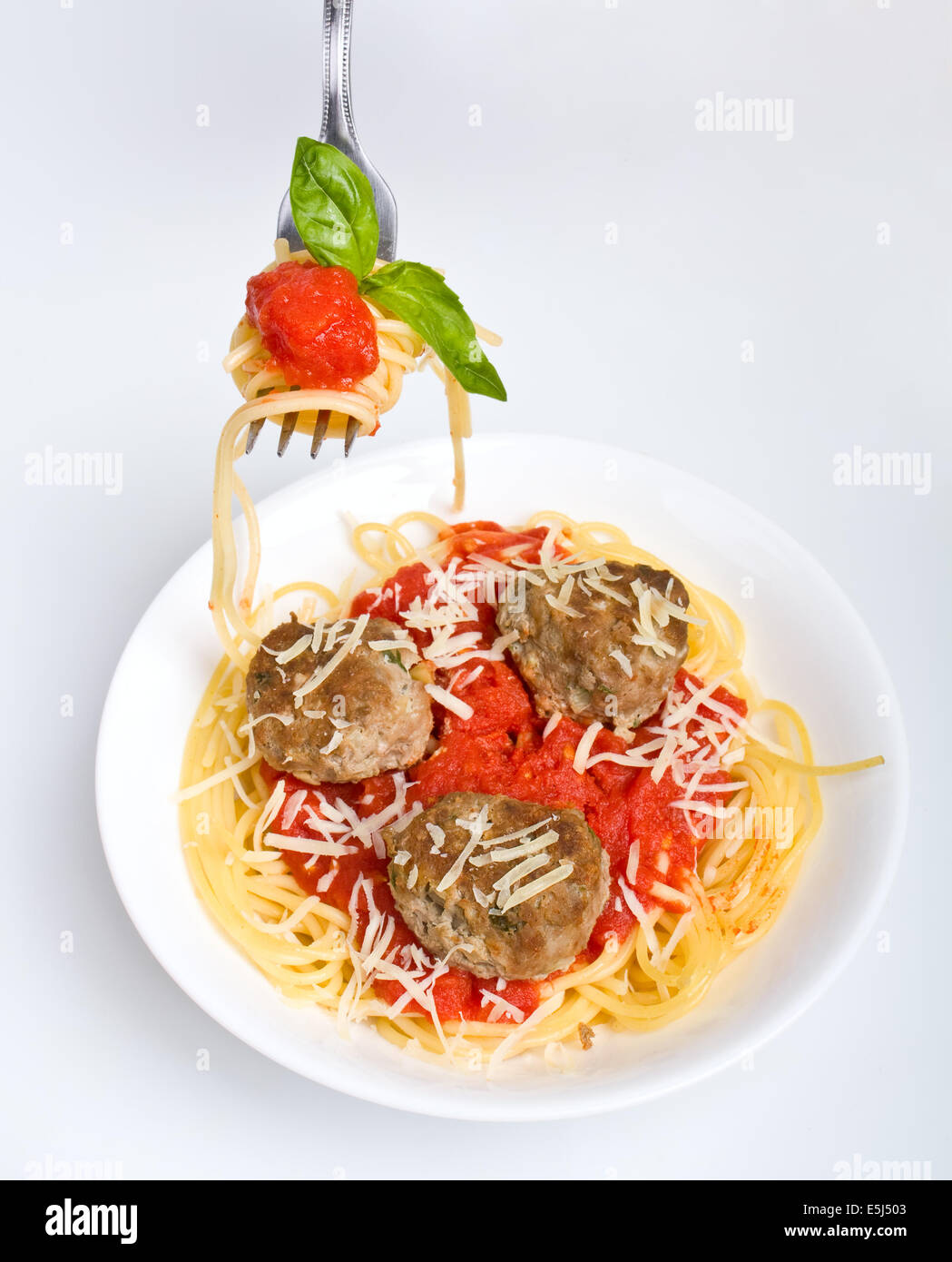 one serving of spaghetti with meatballs in tomato sauce and some ...