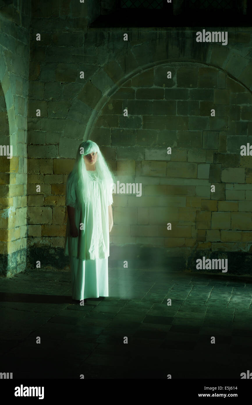 Night scene in a medieval castle with a woman ghost Stock Photo - Alamy
