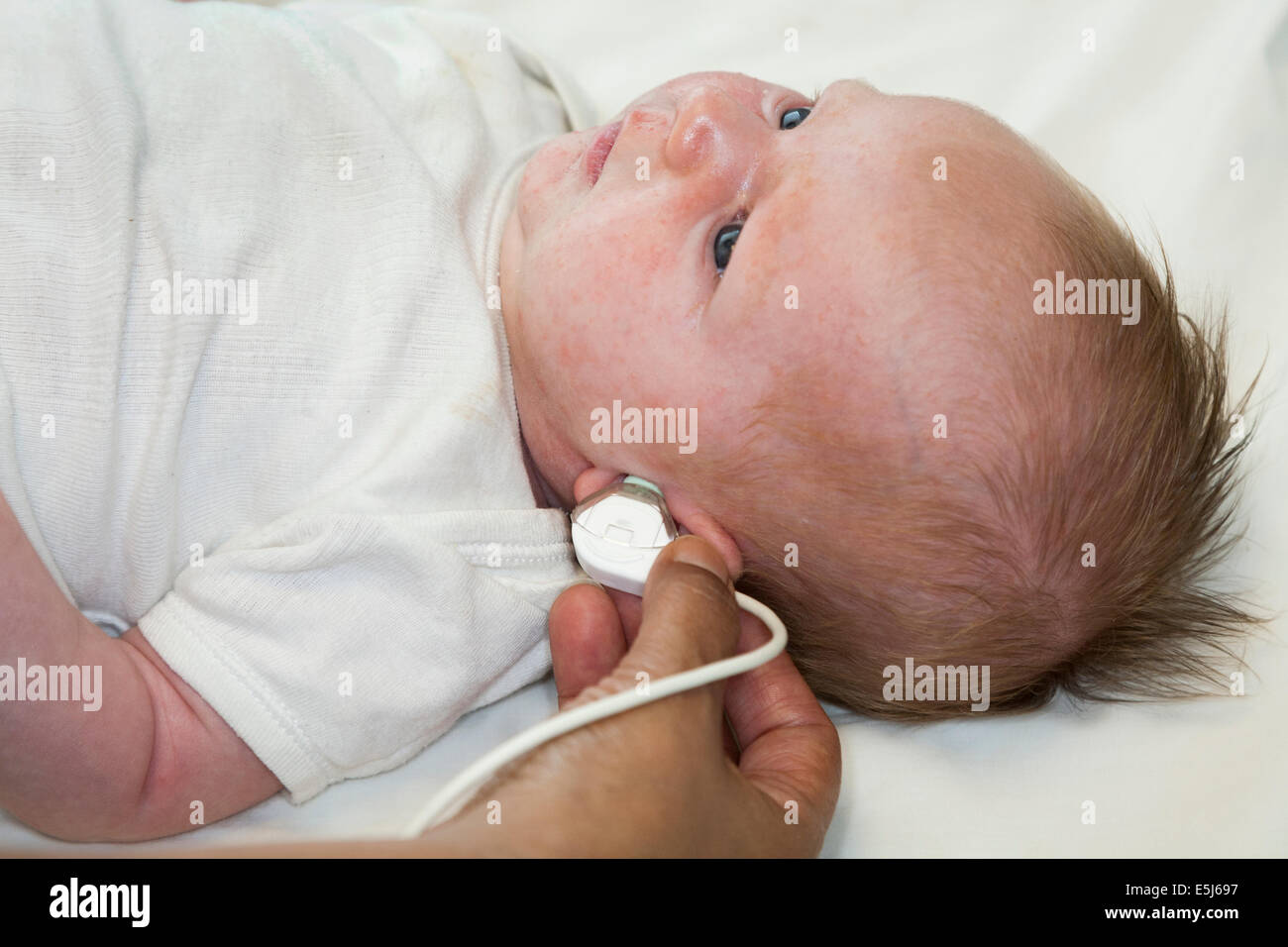 Newborn / new born baby undergoes a neonatal hearing screening test ...